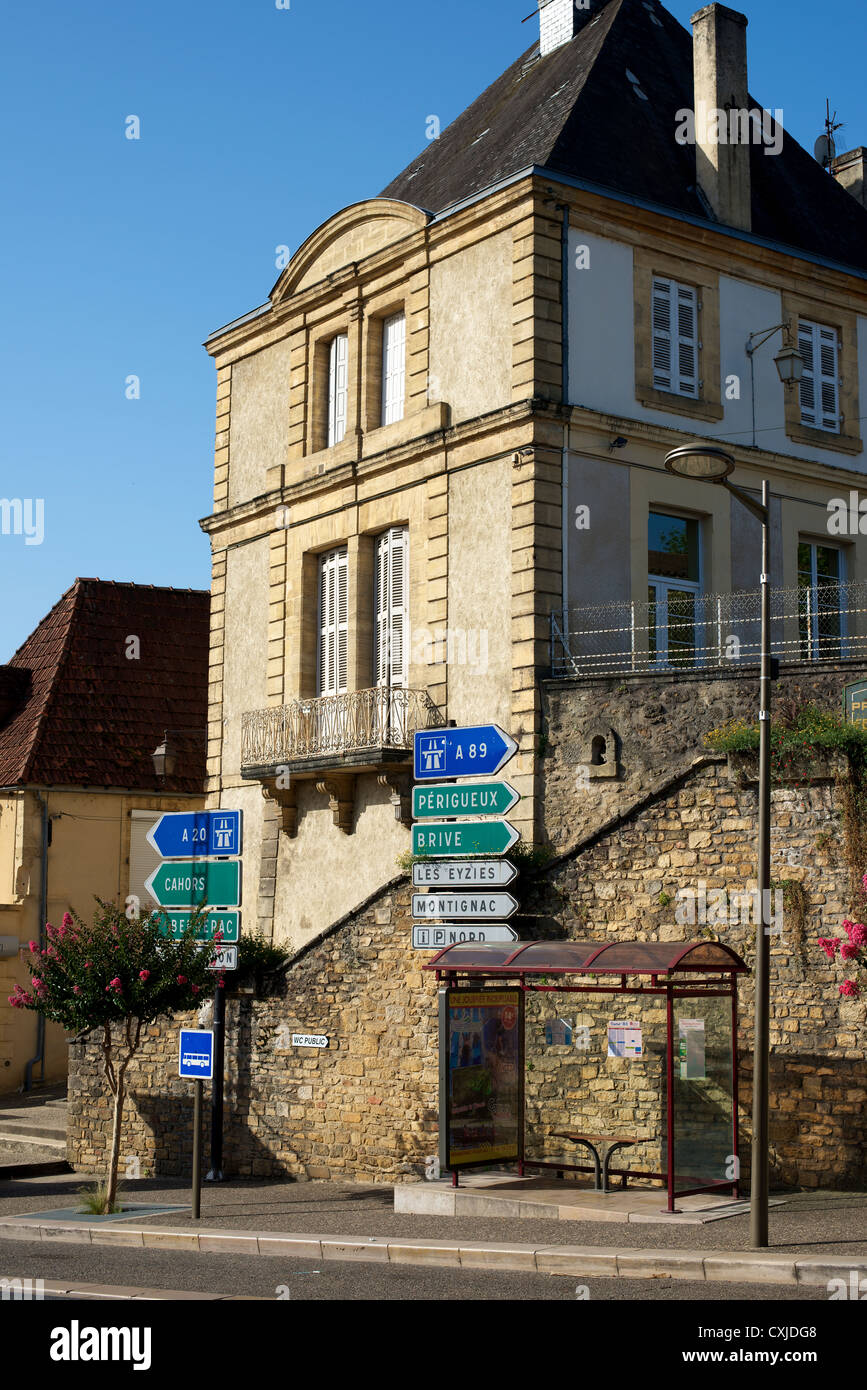 A street with place names, road signs, road names and a bus shelter in ...