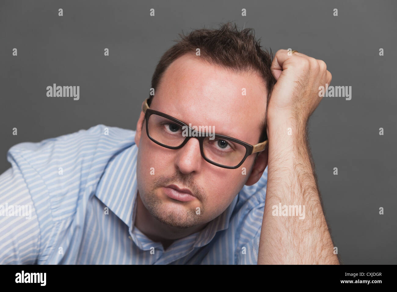 Businessman thinking against gray background Stock Photo - Alamy