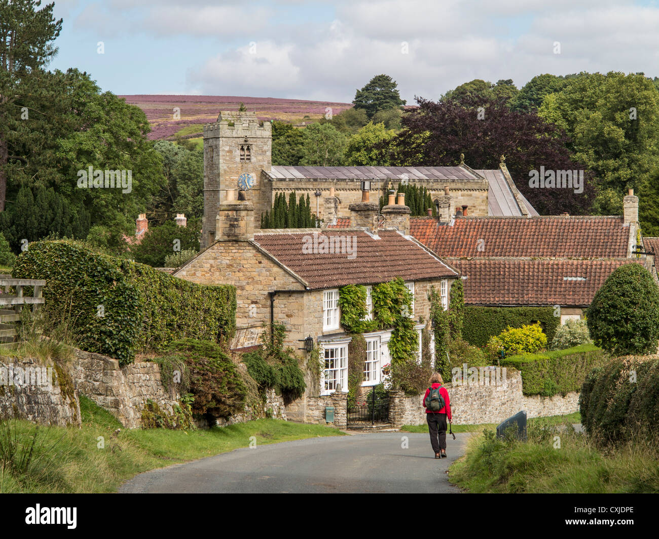 Walker at Lastingham village in the North York Moors National Park UK ...