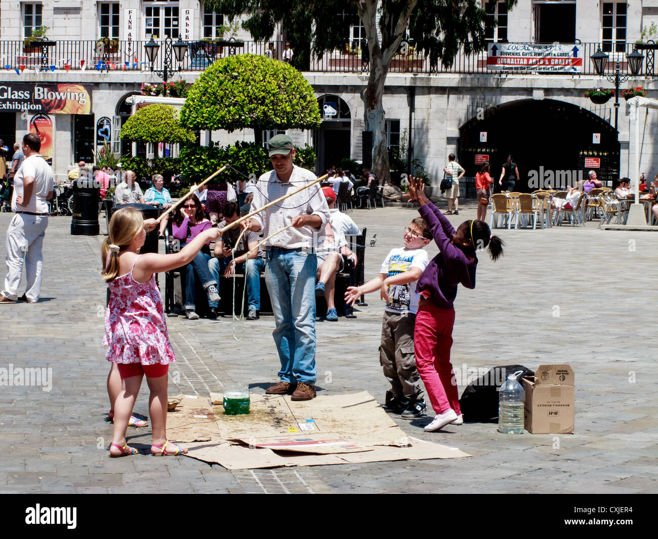 Entertainer in Main square Gibraltar with children, inside the city ...