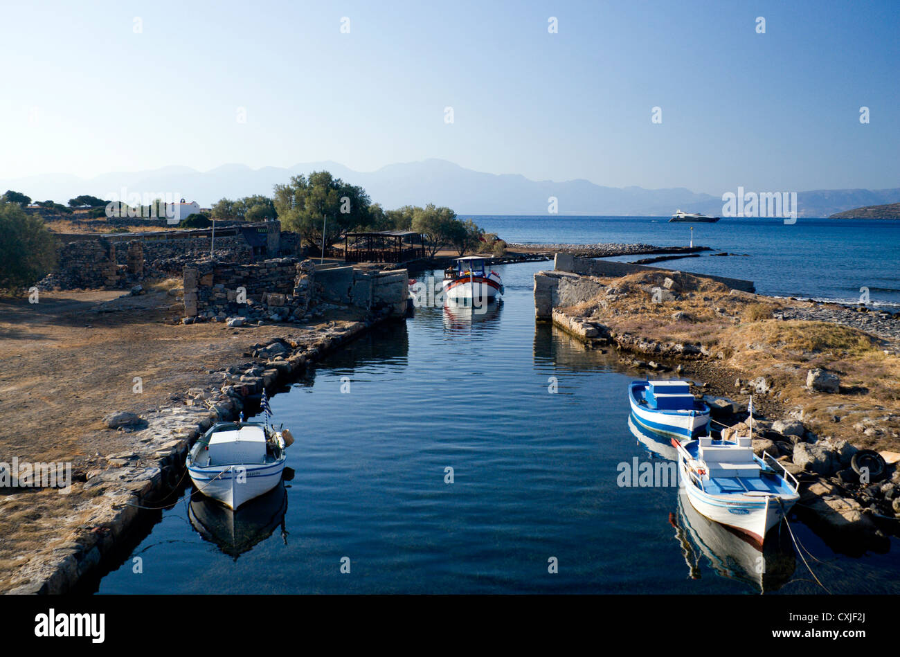 boat on canal causeway leading to kolokitha peninsula elounda crete ...