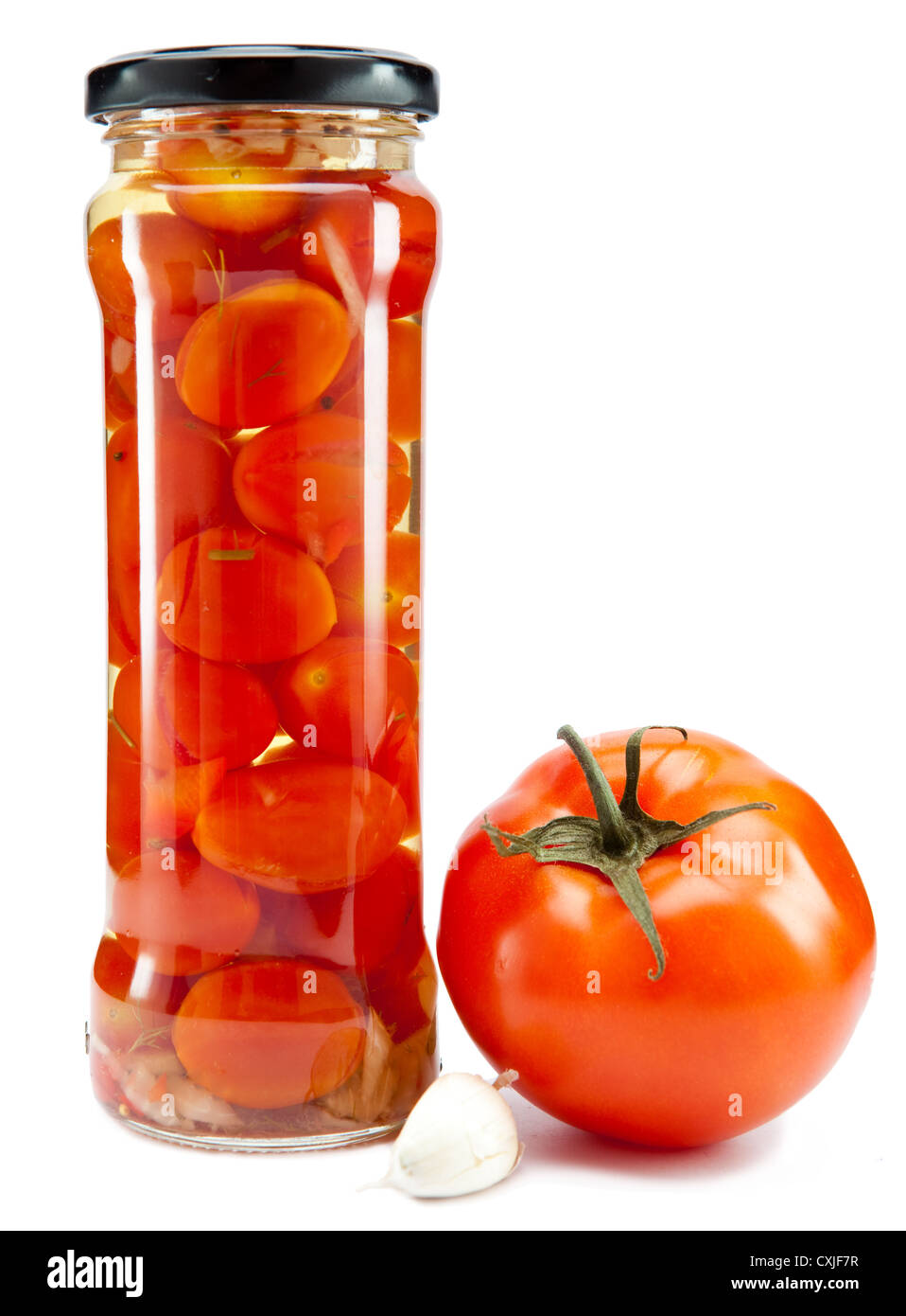 canned tomatoes in glass jar and ripe tomato Stock Photo - Alamy