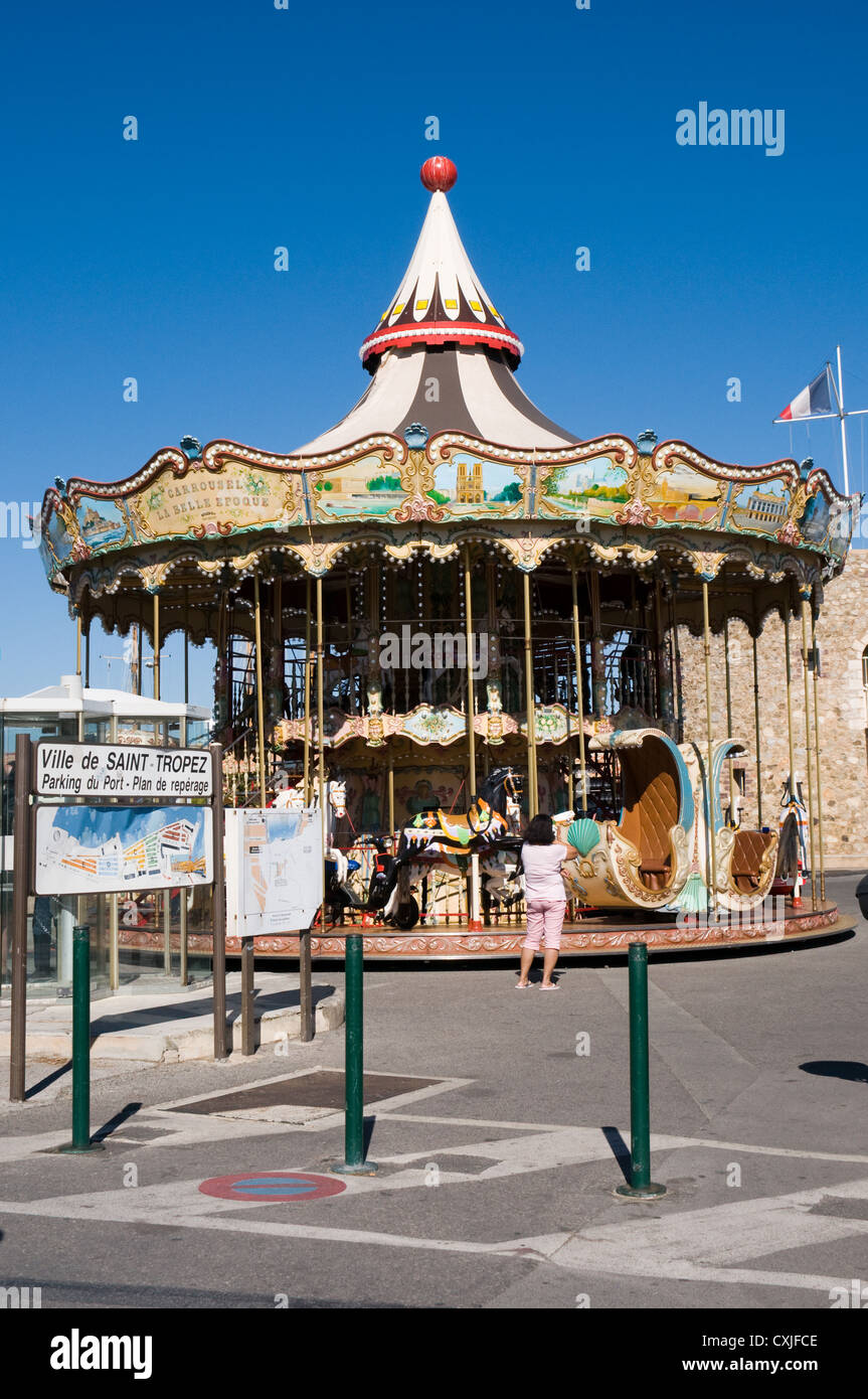A double deck carousel gives rides on the harbor side in the French ...
