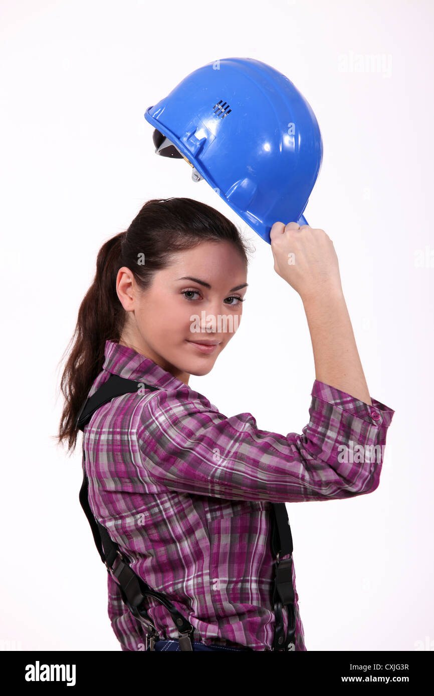 Woman raising her hard hat Stock Photo - Alamy