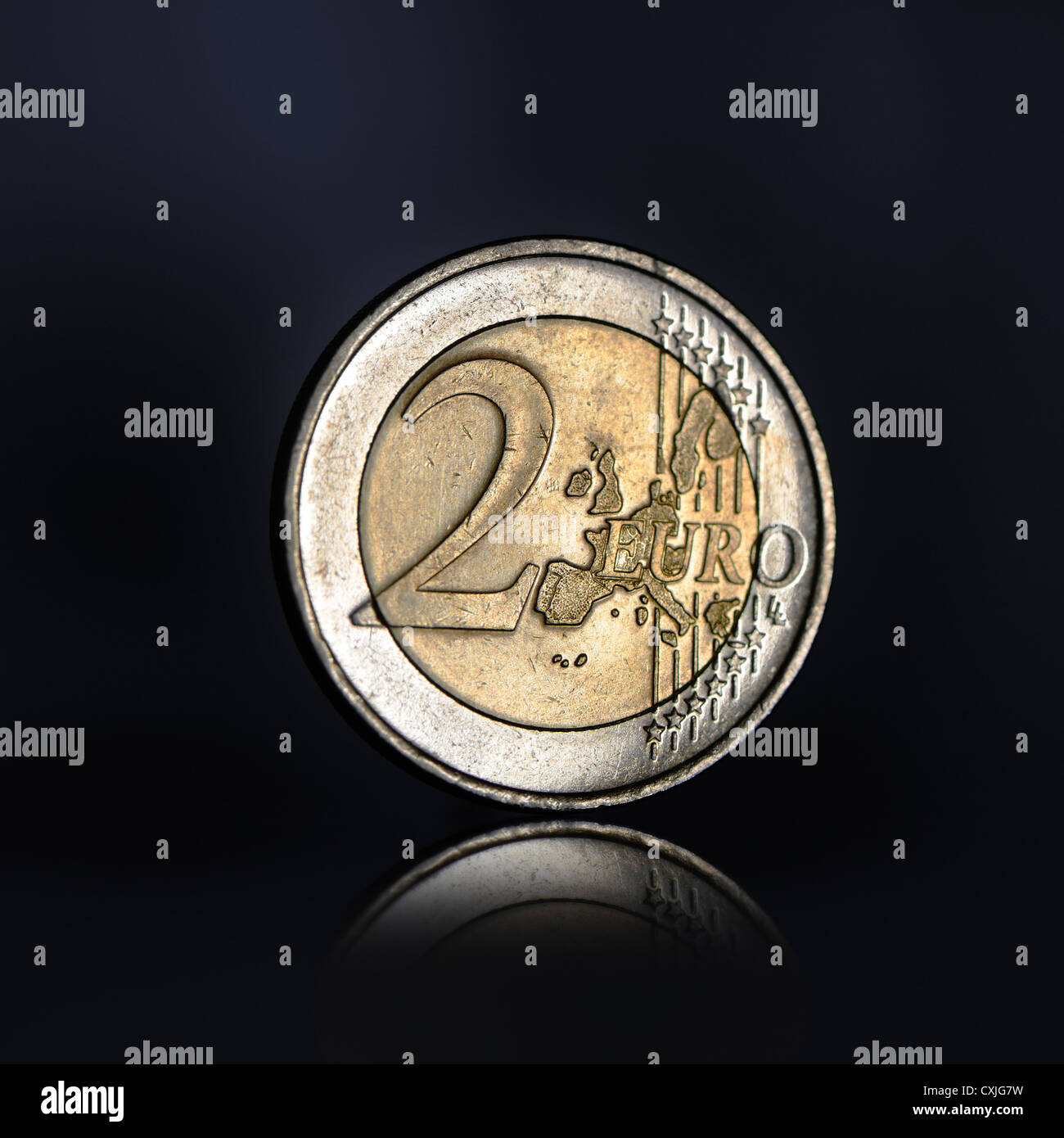 Two euro coin. Dark background with backlight Stock Photo - Alamy