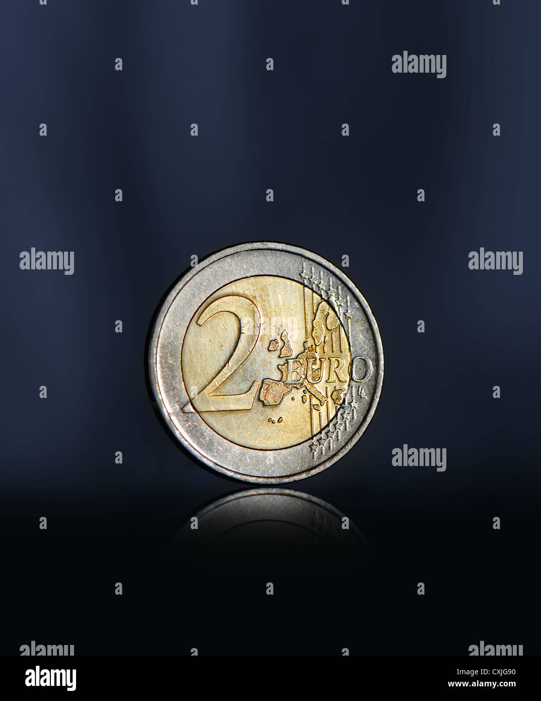 Two euro coin. Dark background with backlight Stock Photo - Alamy