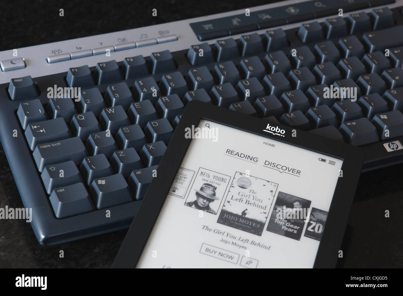 A Kobo touch ereader (ebook) is shown photographed sitting on top of a ...