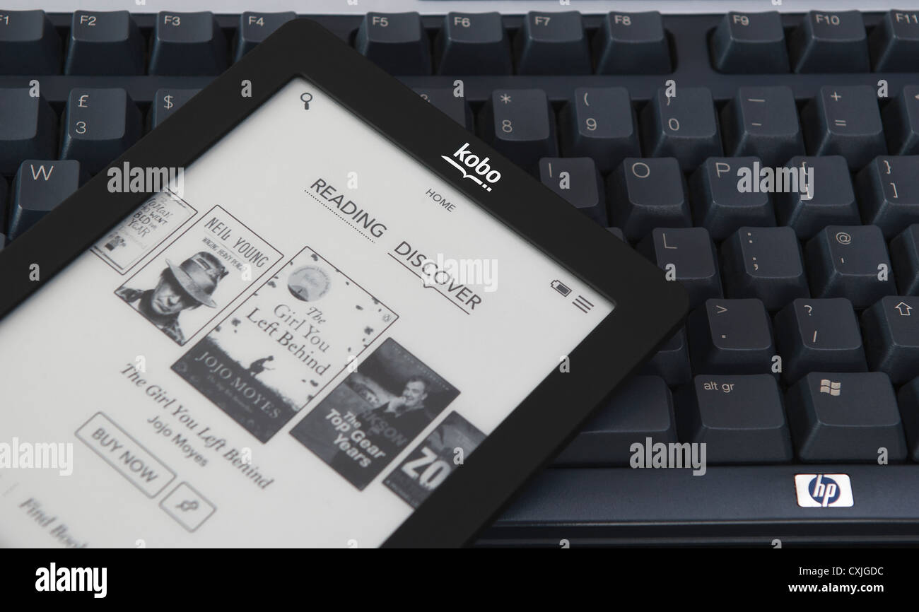 A Kobo touch ereader (ebook) is shown photographed sitting on top of a ...