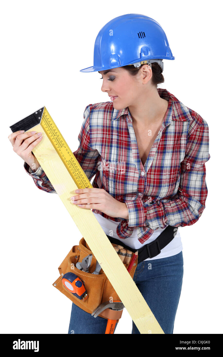 craftswoman measuring a board Stock Photo - Alamy