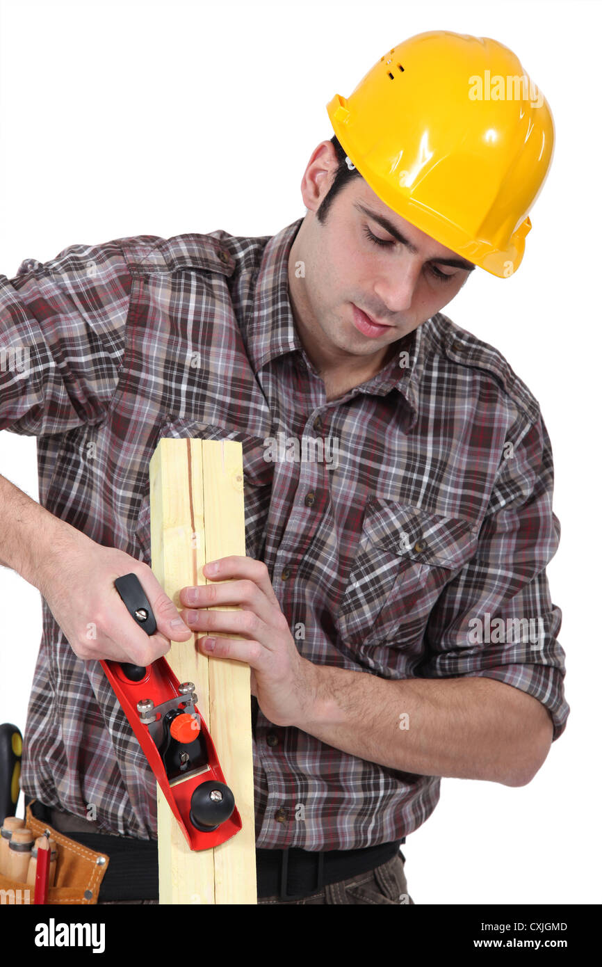 Man planing wood Stock Photo - Alamy