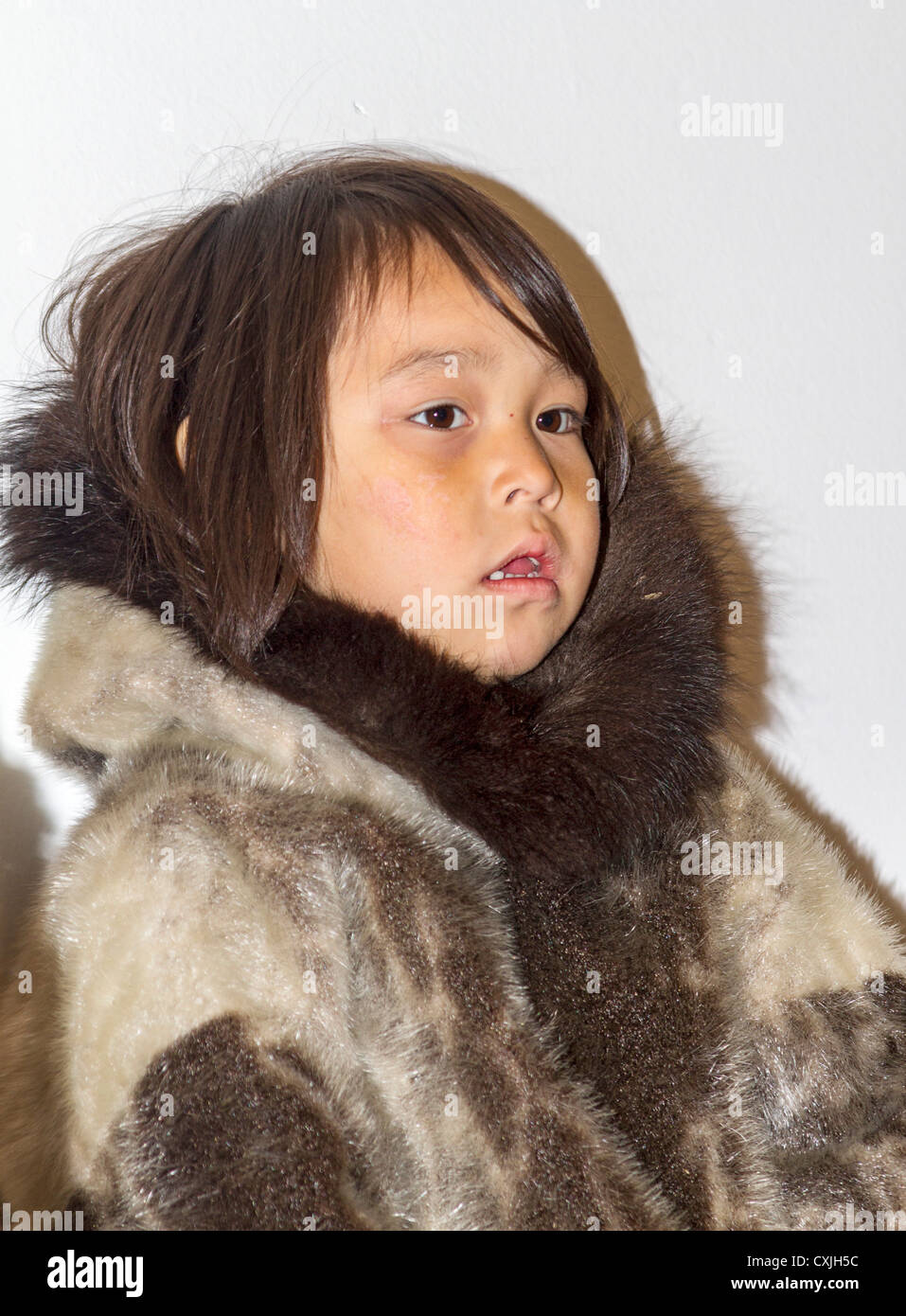 Young Inuit girl in traditional skin clothing. Grise Fjord, Nunavut, northernmost community in ...
