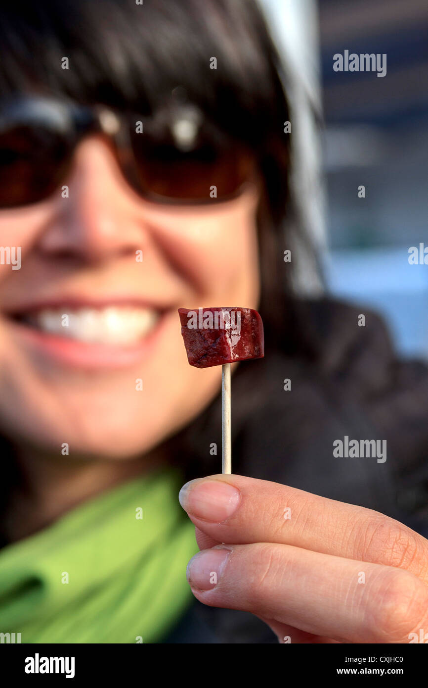 Young woman visitor tries eating 'country food,' as traditional Inuit ...