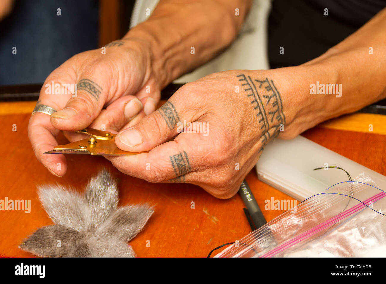 Inuit woman demonstrates seal skin cutting and sewing techniques Stock ...