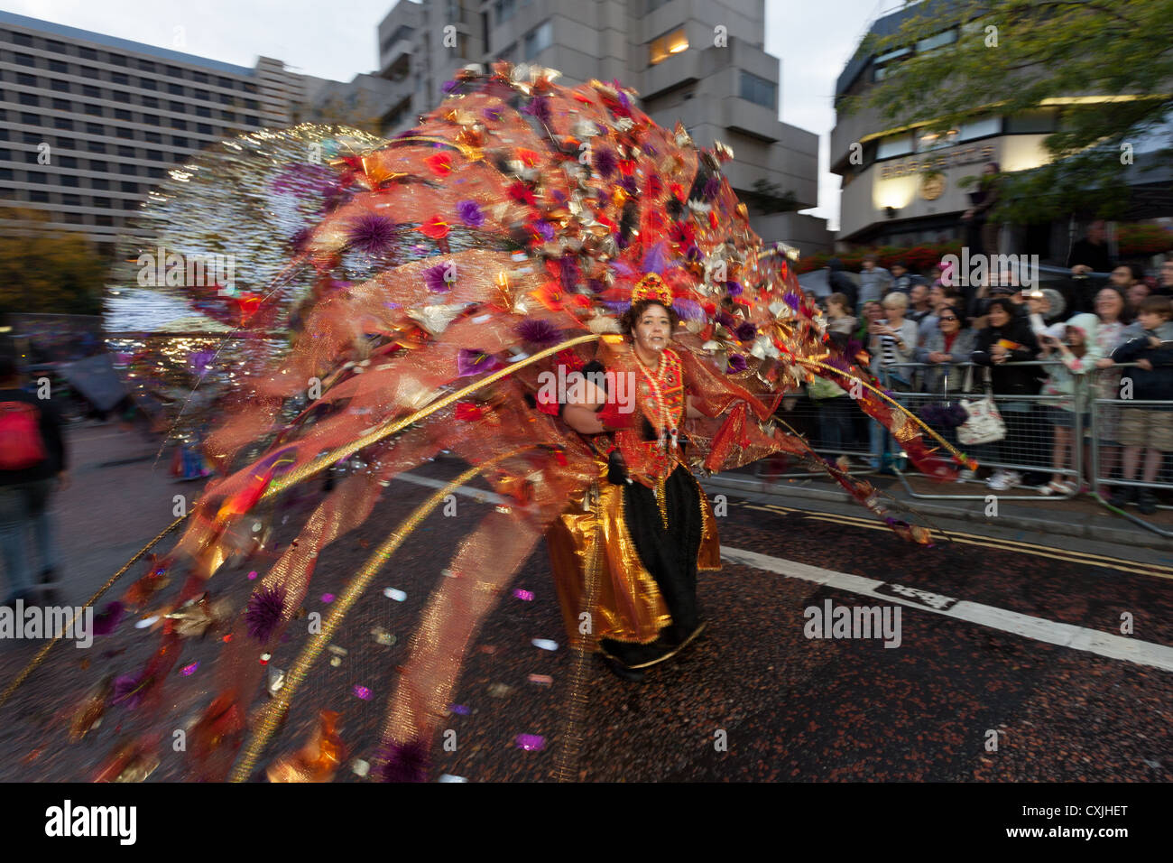 Dancer in outlandish costume during street parade, Thames Festival ...