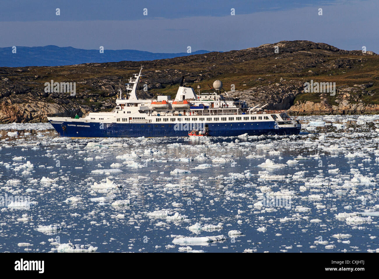 Cruise ship Clipper Adventurer sits at anchor in ice choked harbor of ...