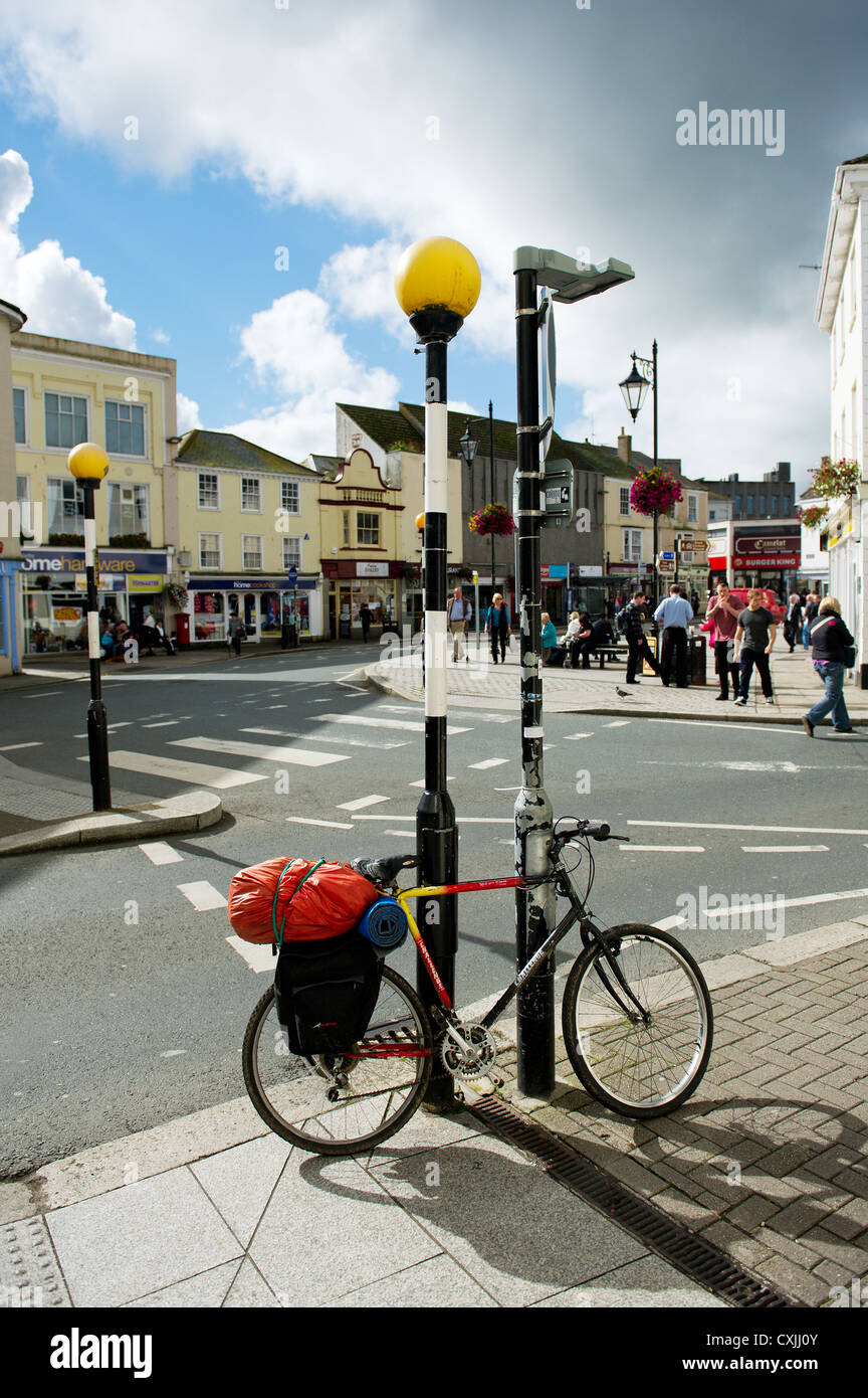 A bicycle leaning against a post on the roadside in Truro Stock Photo ...