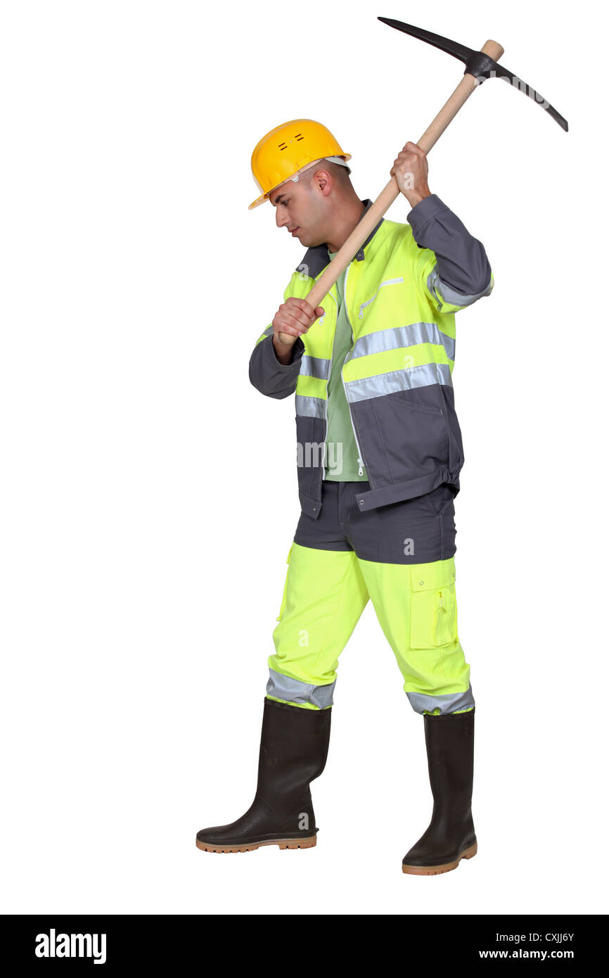 Laborer using pickaxe on white background Stock Photo - Alamy
