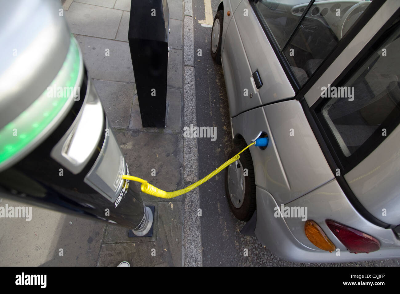 g-whiz Electric car at charging point in London; with charge point ...