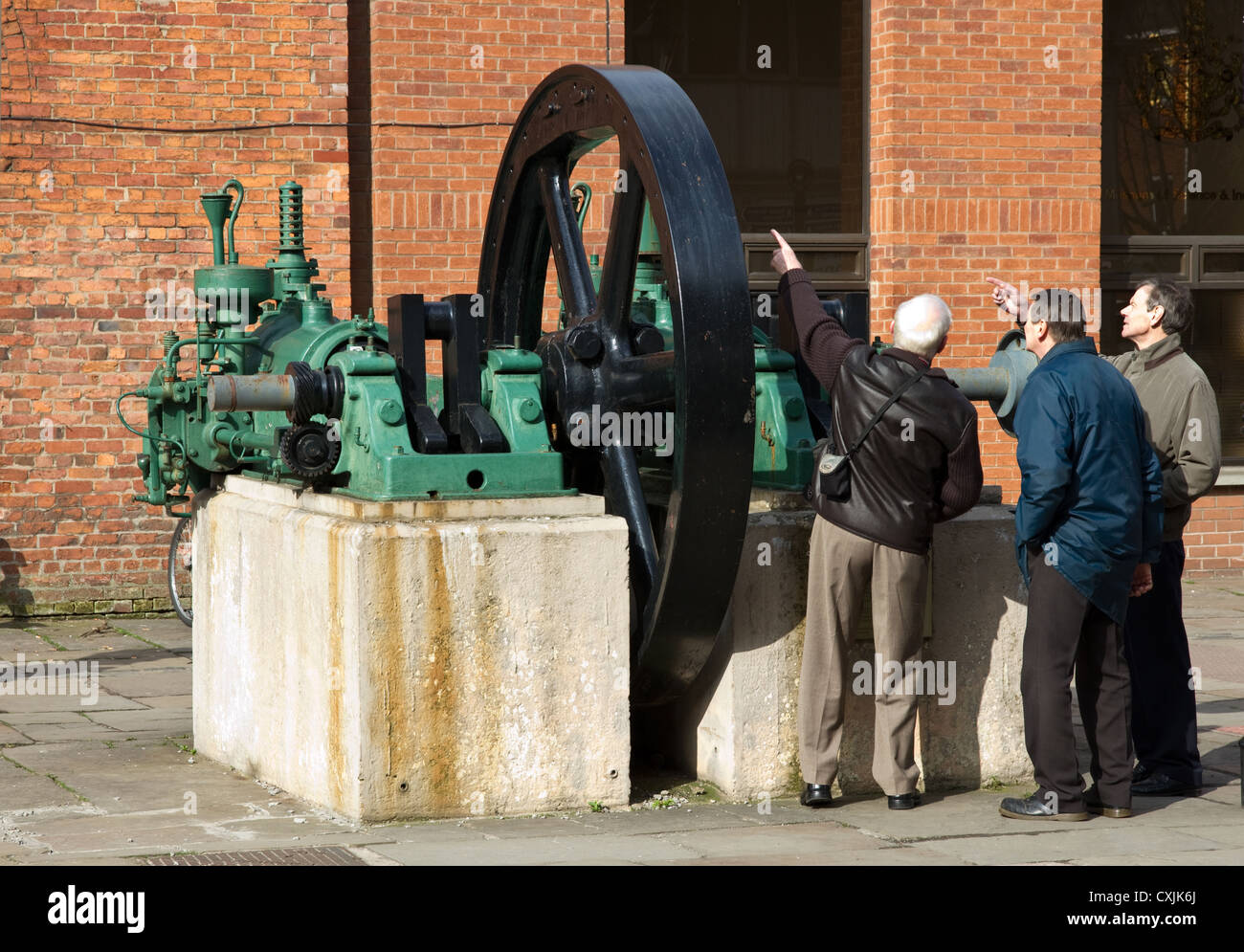 Visitors discussing an old Crossley engine exhibit outside the Museum ...