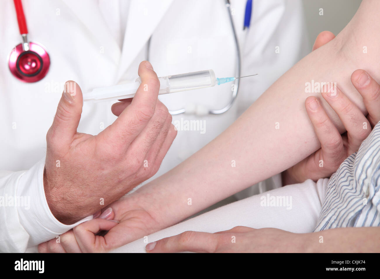 Doctor jabbing patient with syringe Stock Photo - Alamy