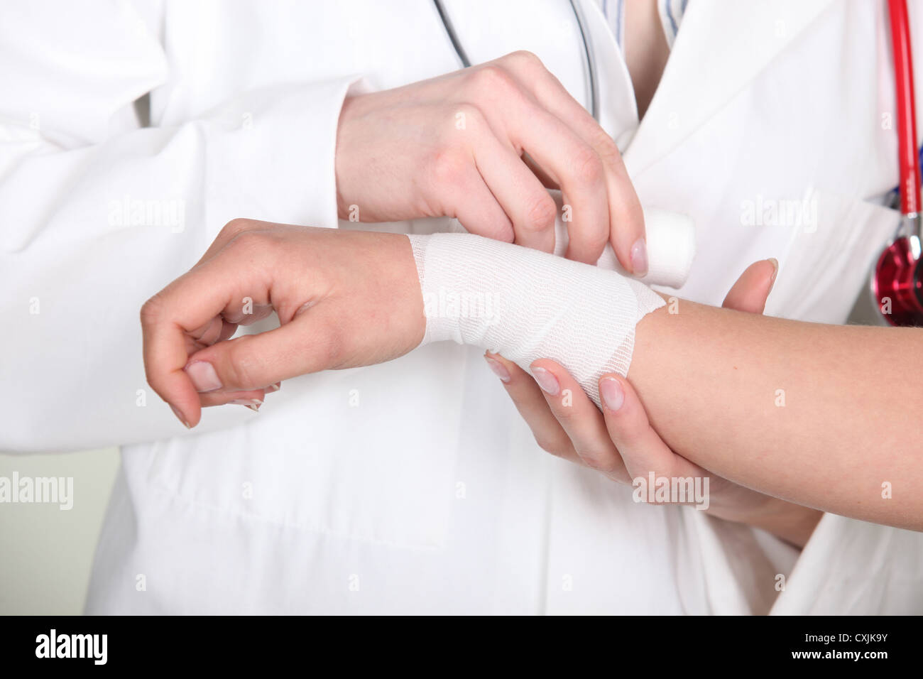 Doctor putting bandage on wrist Stock Photo - Alamy