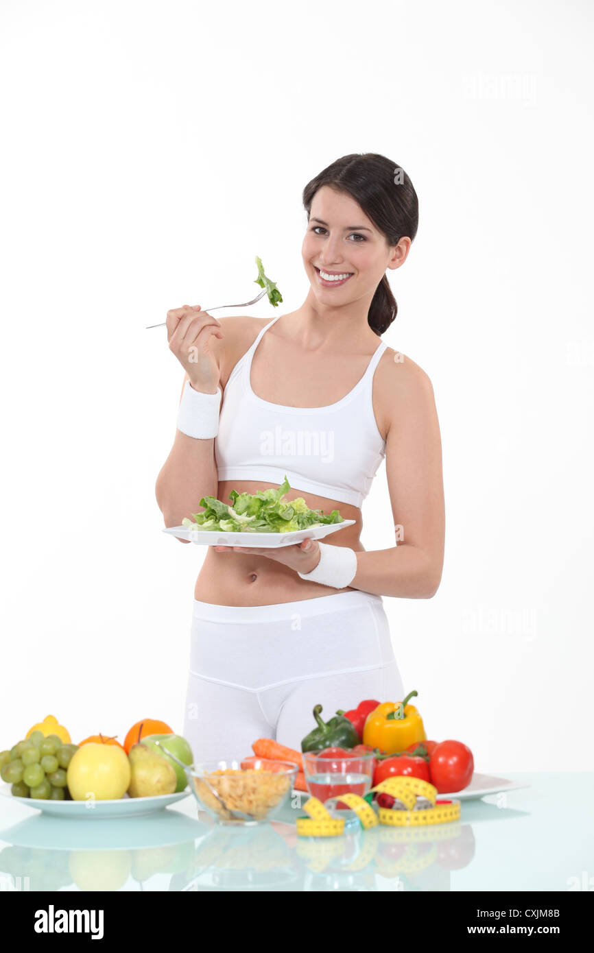 Woman eating a plateful of salad leaves Stock Photo - Alamy