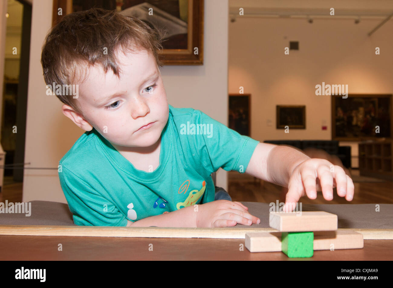 Small boy playing with building blocks Stock Photo - Alamy