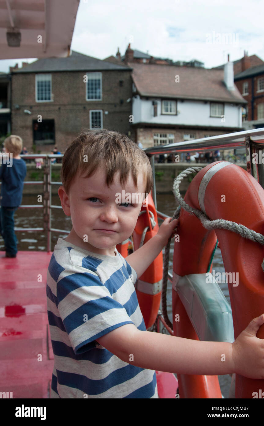 Boy driving boat hi-res stock photography and images - Alamy