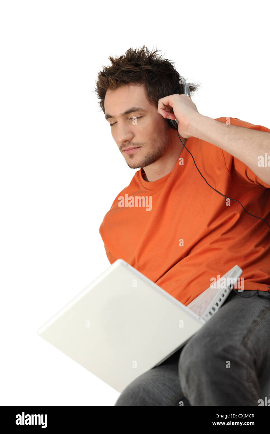 Man listening to music on computer Stock Photo - Alamy