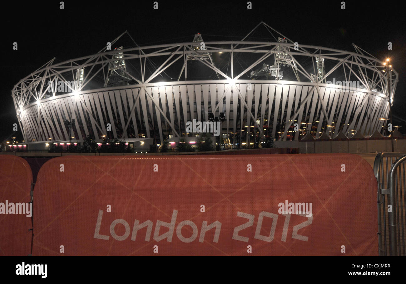 The Olympic Stadium with a 'London 2012' sign. Olympic Park at night ...