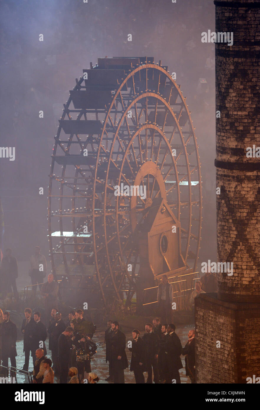 Workers and large water wheel Stock Photo - Alamy