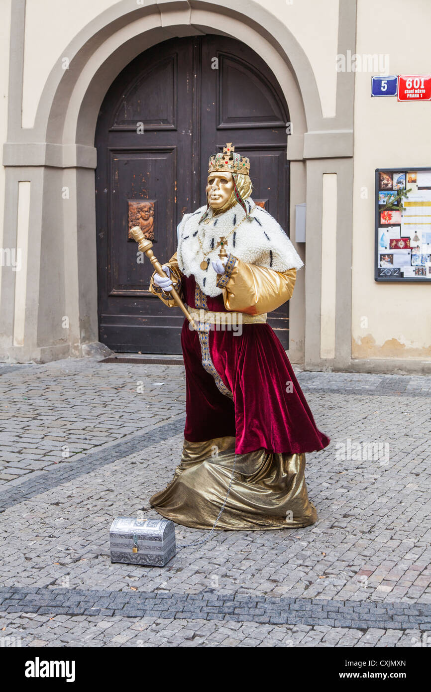 Person posing as a golden statute in royal robes, Prague, Czech ...