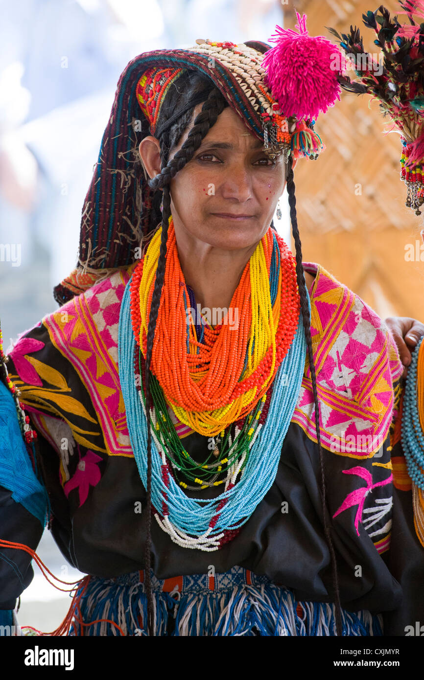 Kalash woman wearing a cowrie shell headdress (shushut) and coloured ...