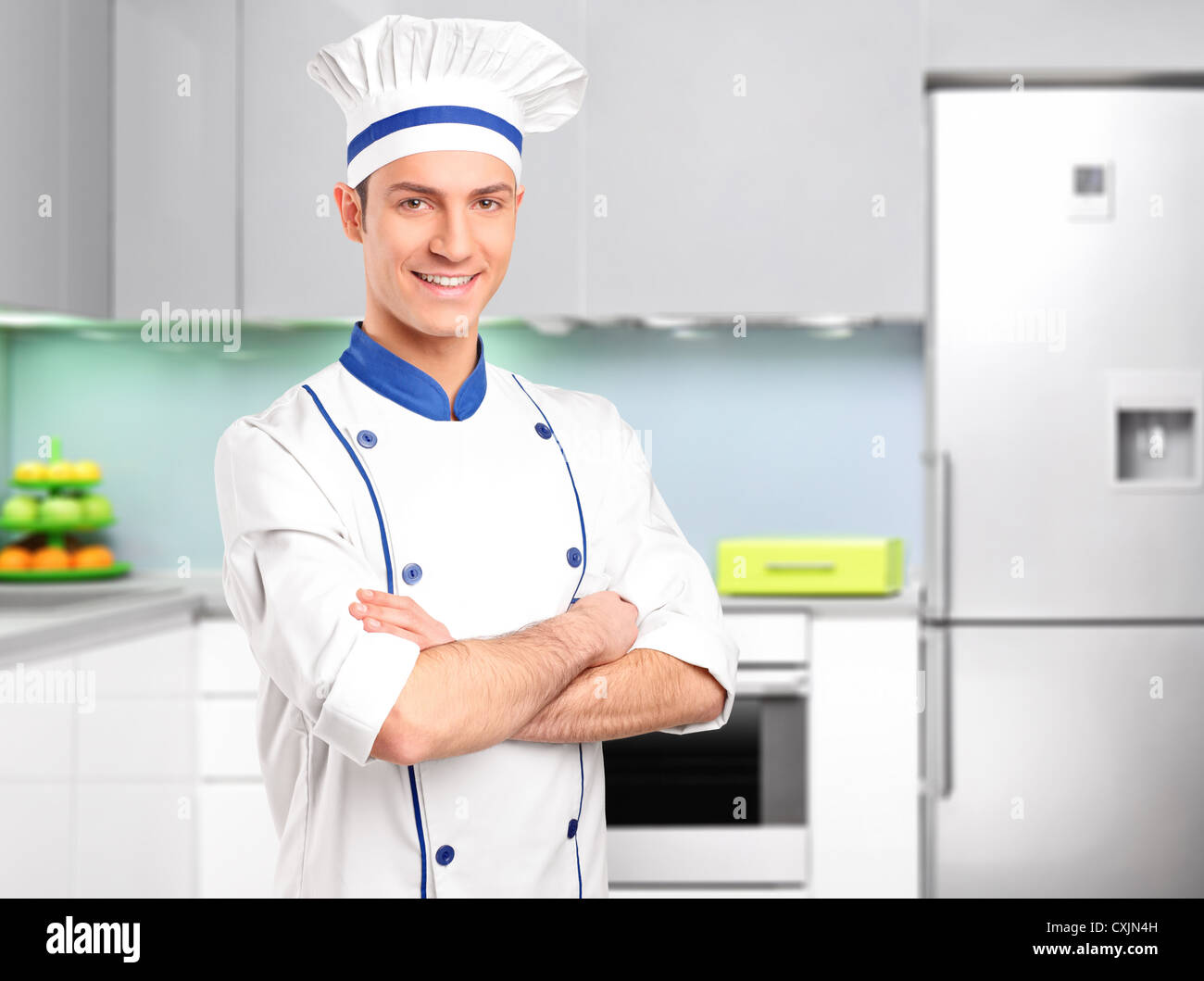Male chef standing in a kitchen Stock Photo - Alamy