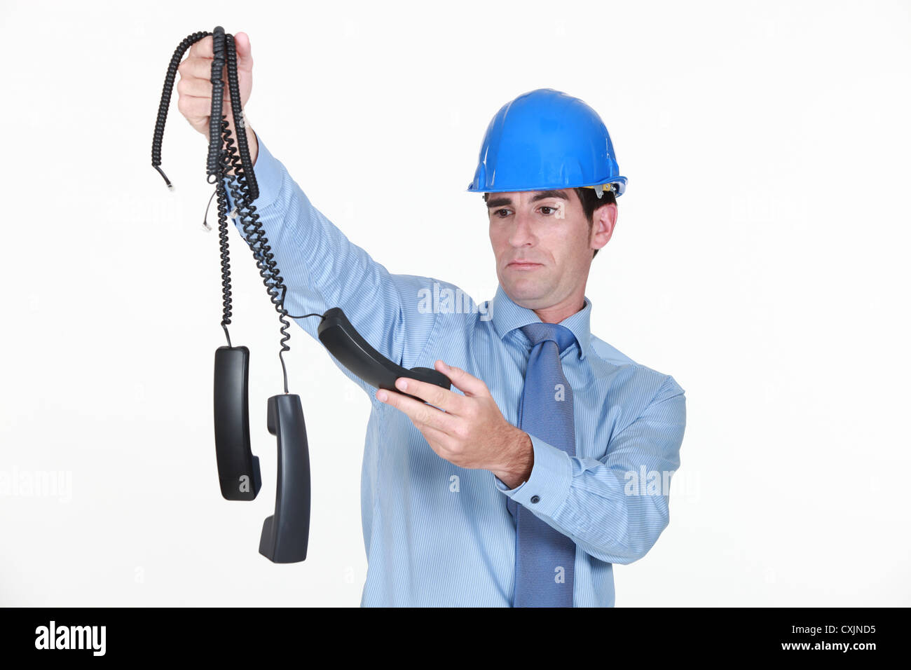 Entrepreneur holding unplugged phones Stock Photo - Alamy