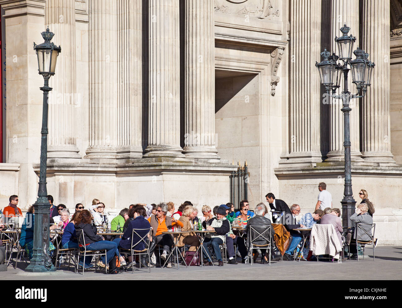 Visitors to the Musée du Louvre, Paris, France, eating, drinking and ...