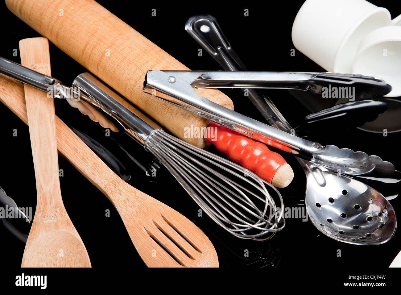 Various cooking utensils on black cloth Stock Photo - Alamy