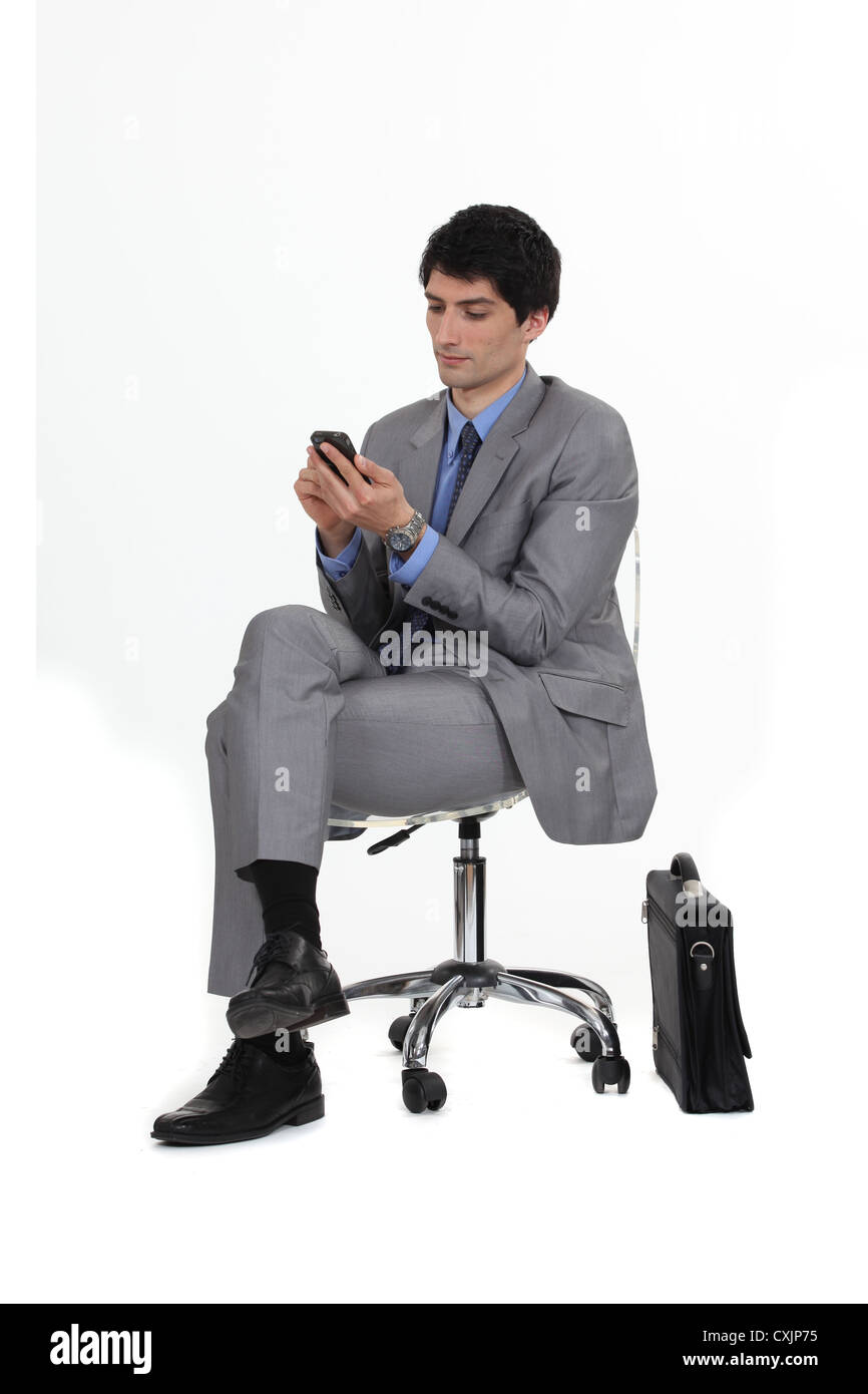 Businessman looking smartphone Cut Out Stock Images & Pictures - Alamy