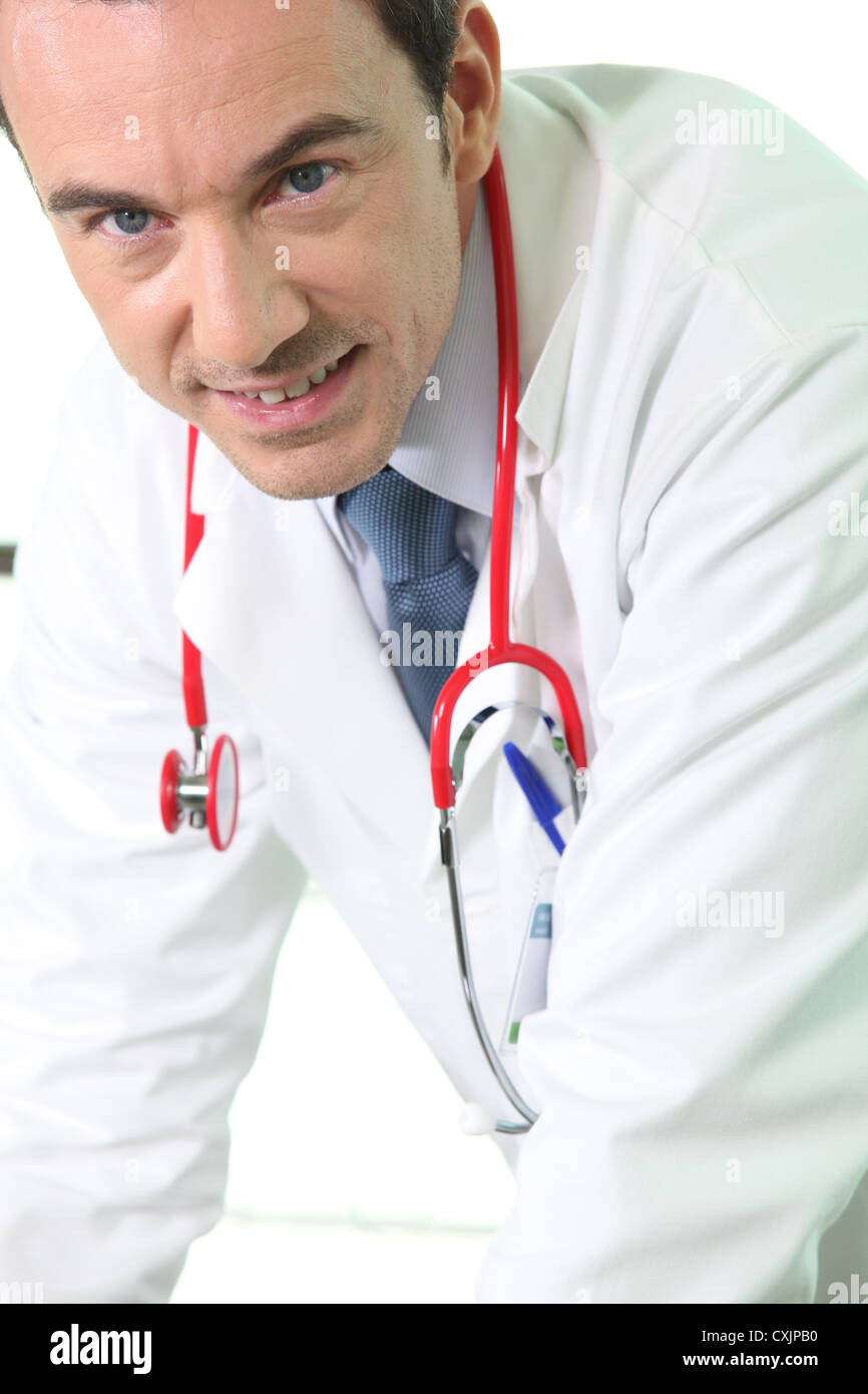 Doctor stooping over Stock Photo - Alamy