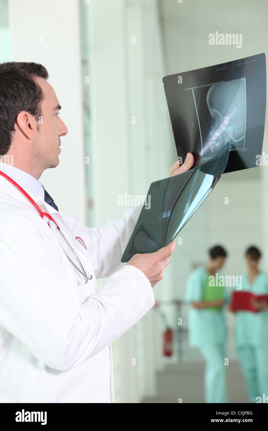 Orthopedic surgeon with two x-rays Stock Photo - Alamy