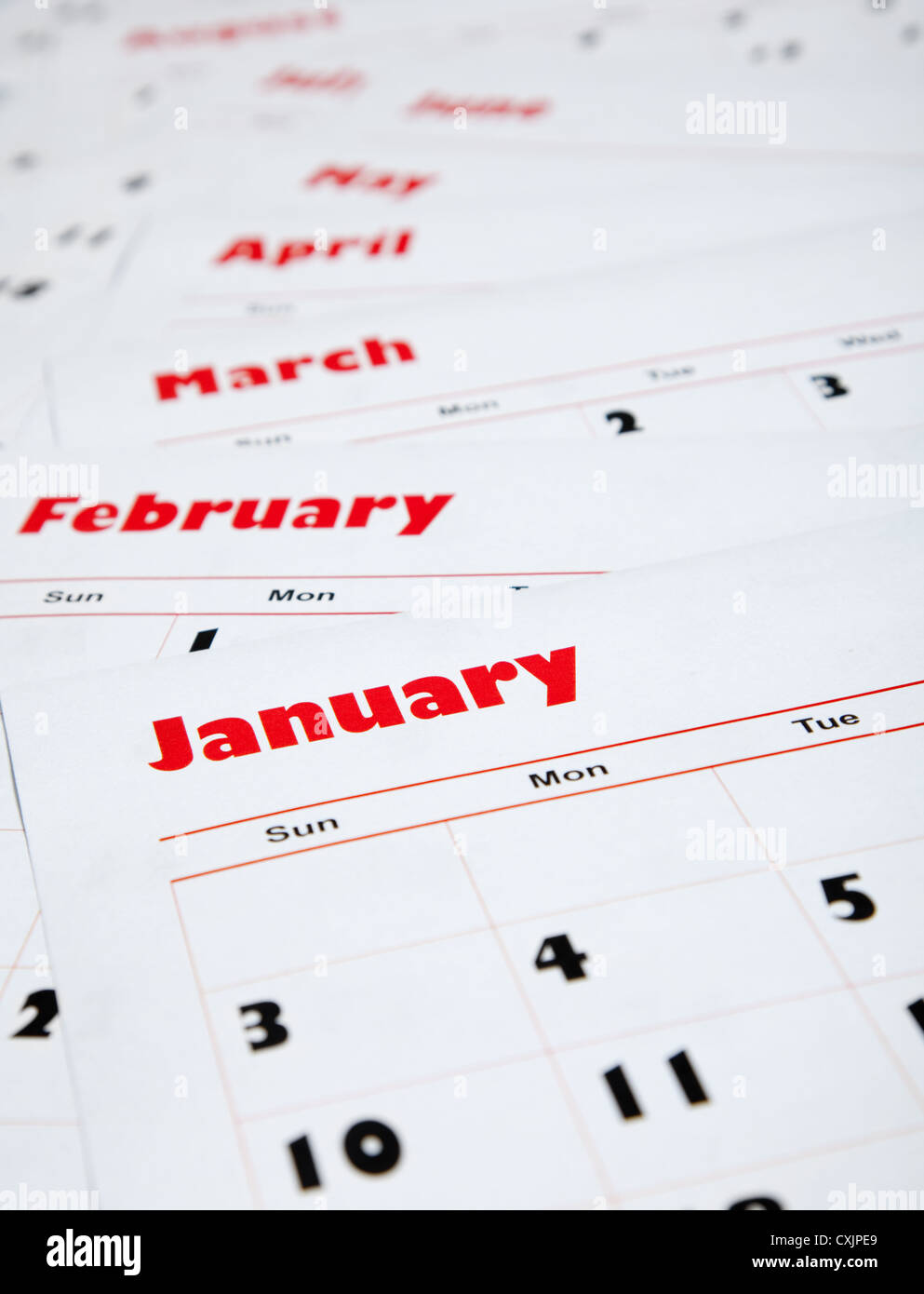 Stack of monthly calendars in red ink Stock Photo - Alamy