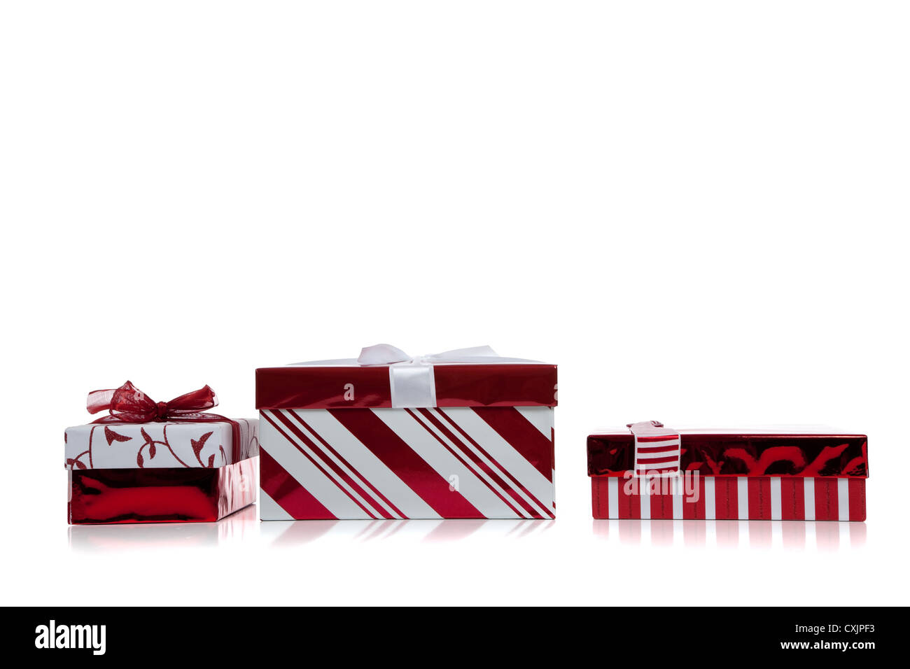 Row of red and white wrapped Christmas presents on a white background ...