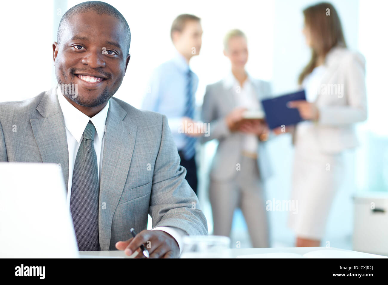 Portrait of happy boss looking at camera in working environment Stock ...