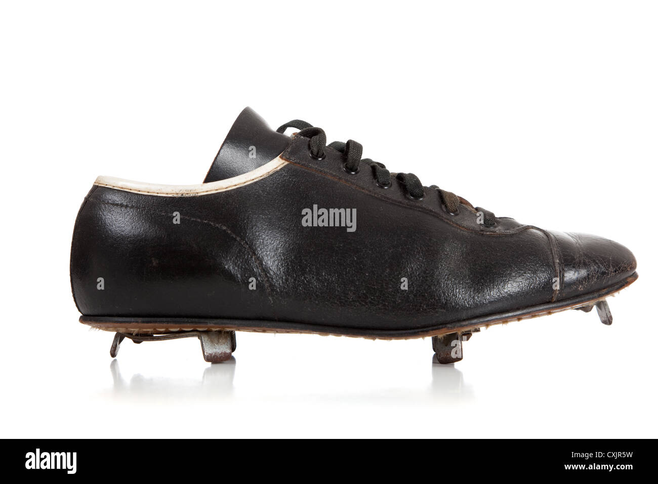 A vintage black sports cleat on a white background Stock Photo - Alamy