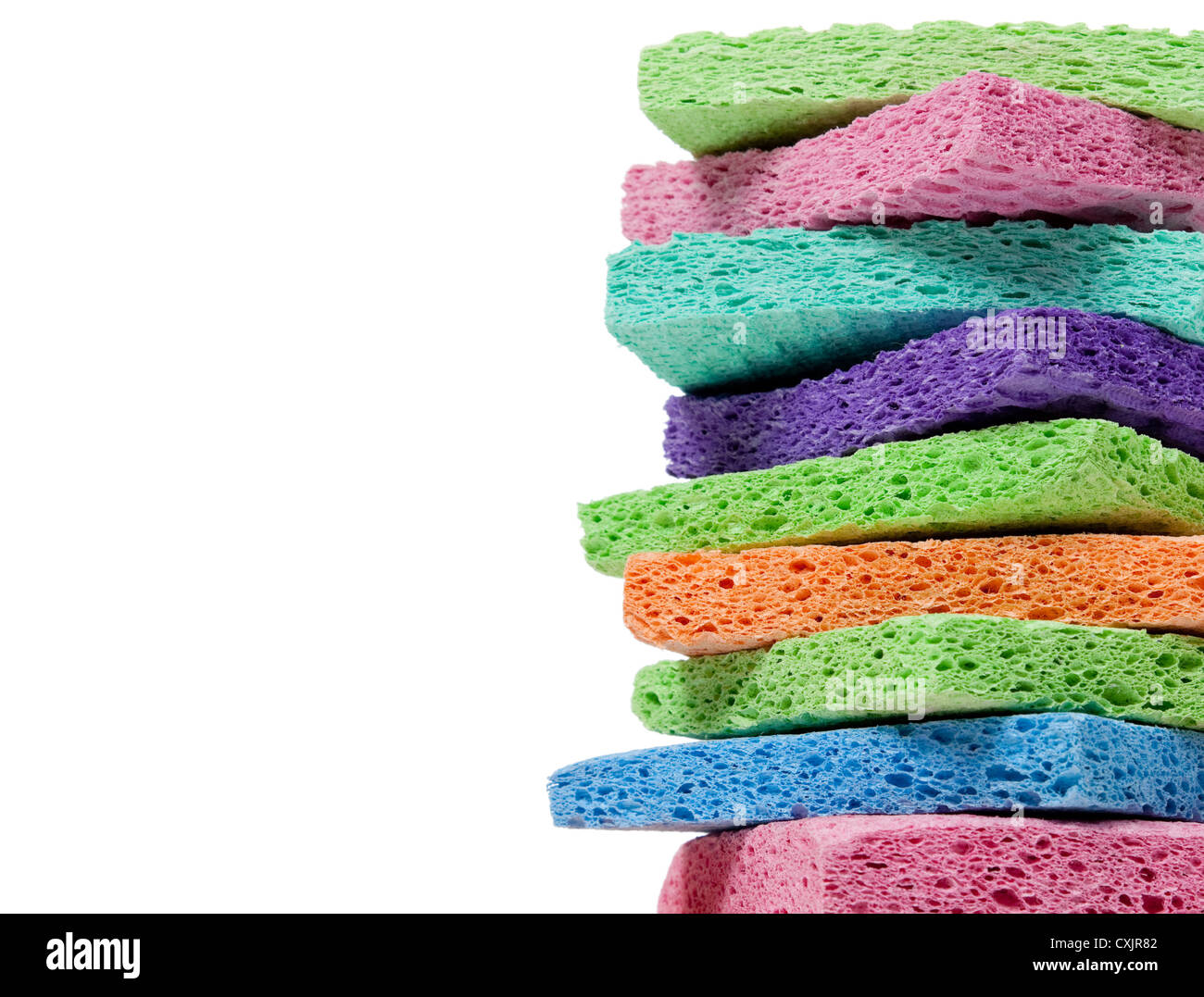 stack of multicolored sponges on a white background with copy space ...