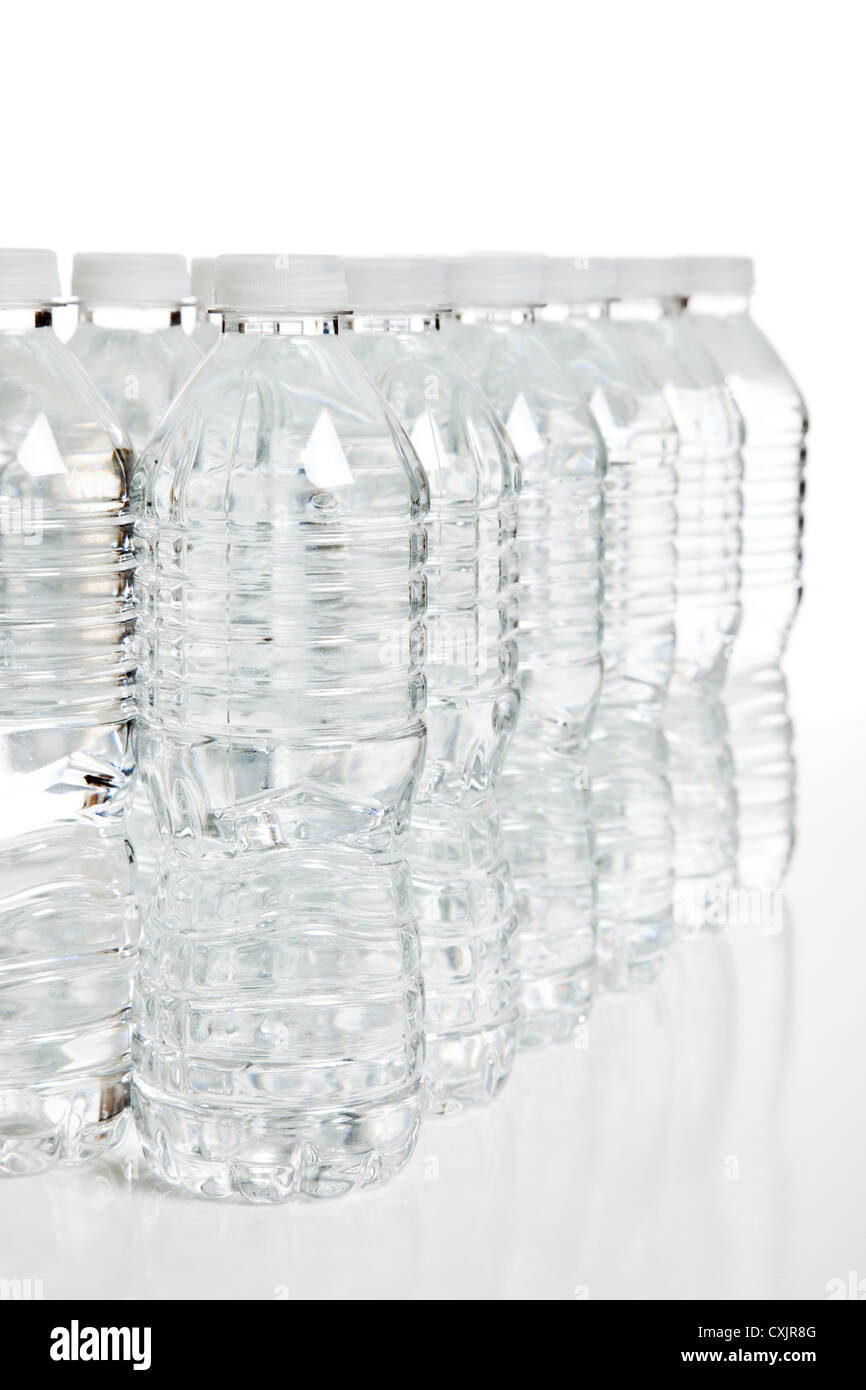 Row of unlabeled water bottles on a white background Stock Photo - Alamy