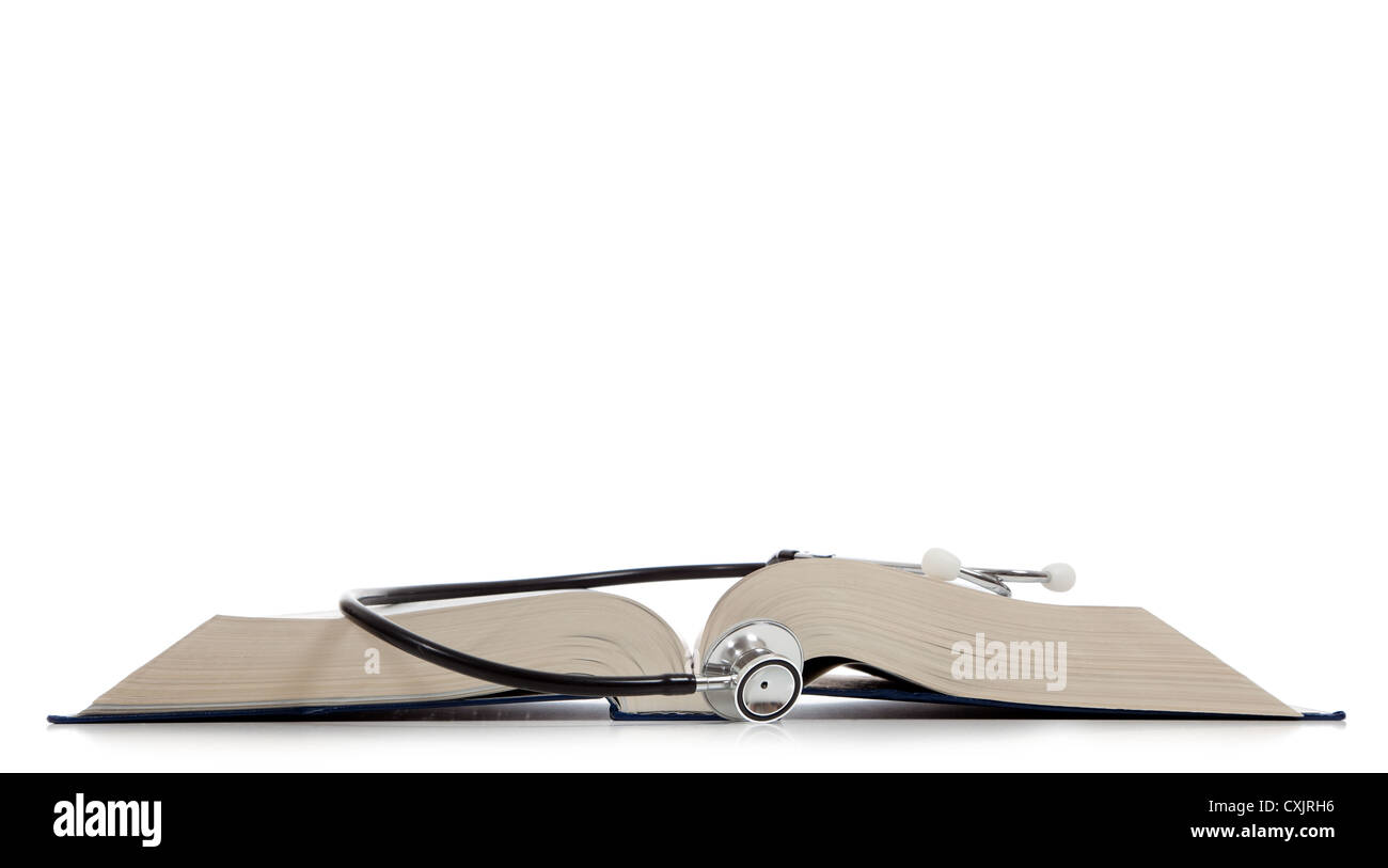 Medical reference book with stethoscope on a white background with copy ...