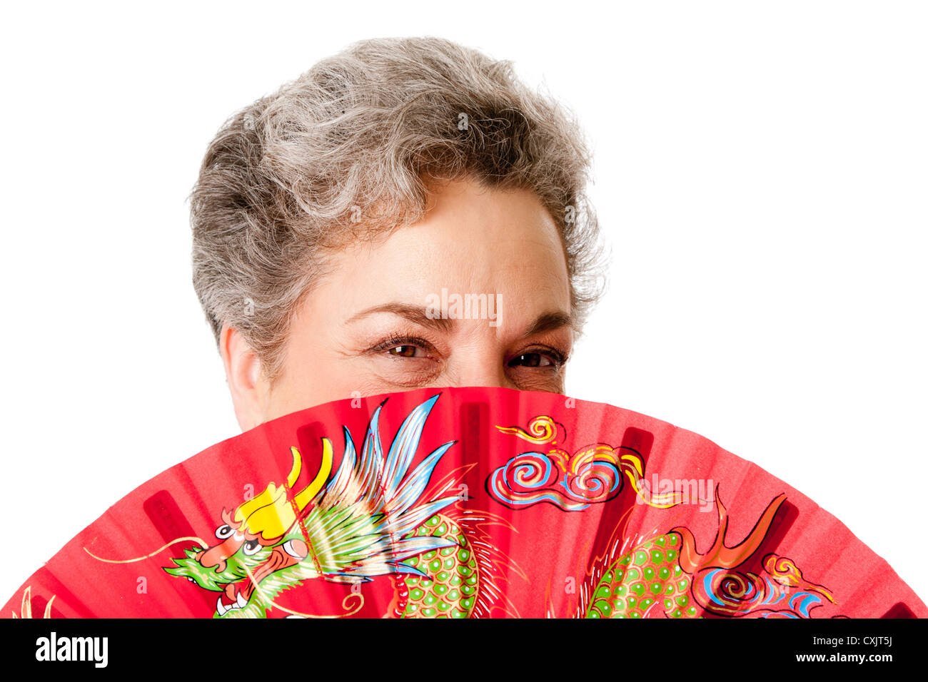 Senior woman with red dragon fan Stock Photo - Alamy