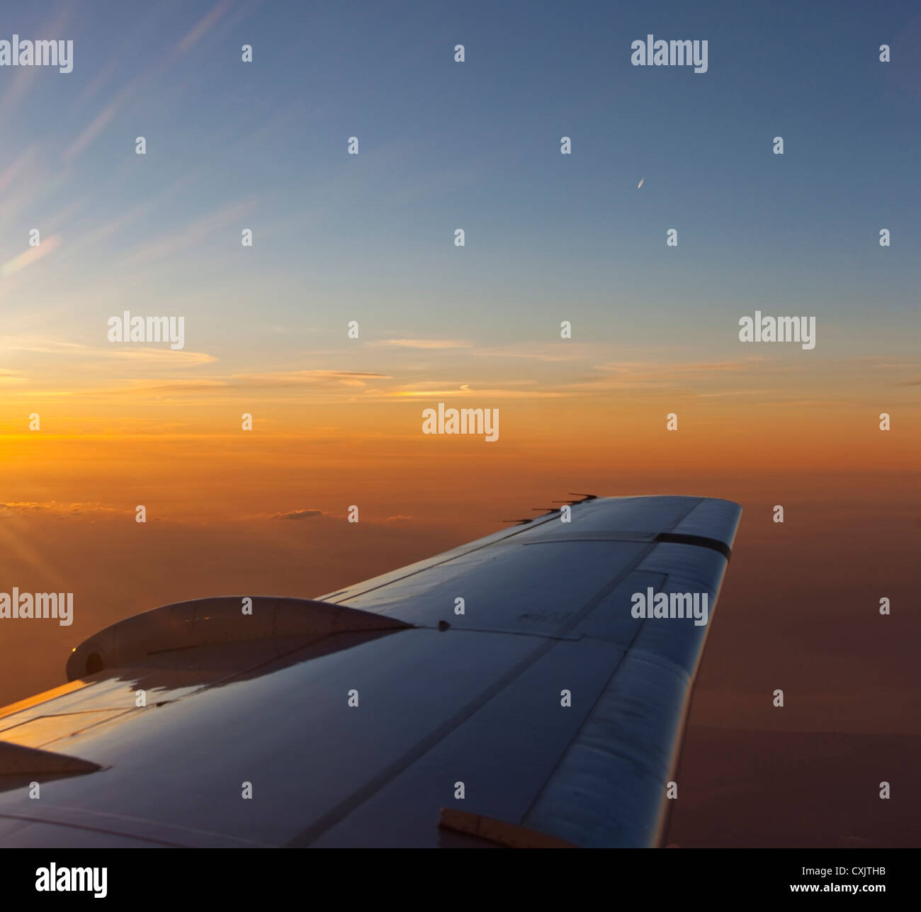 Sunset above wing of an airplane with Romantic sky Stock Photo - Alamy