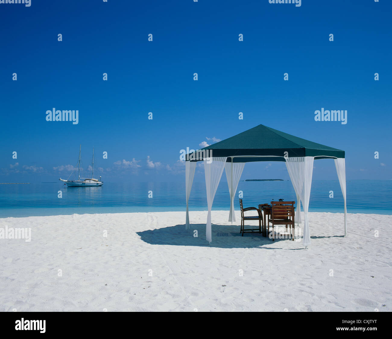 Table set at the beach and yacht Stock Photo - Alamy